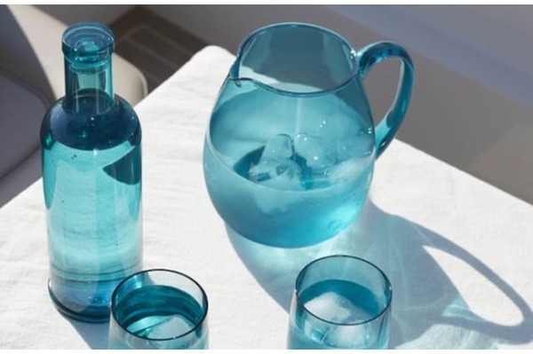 Glass of turquoise water from Marine Business